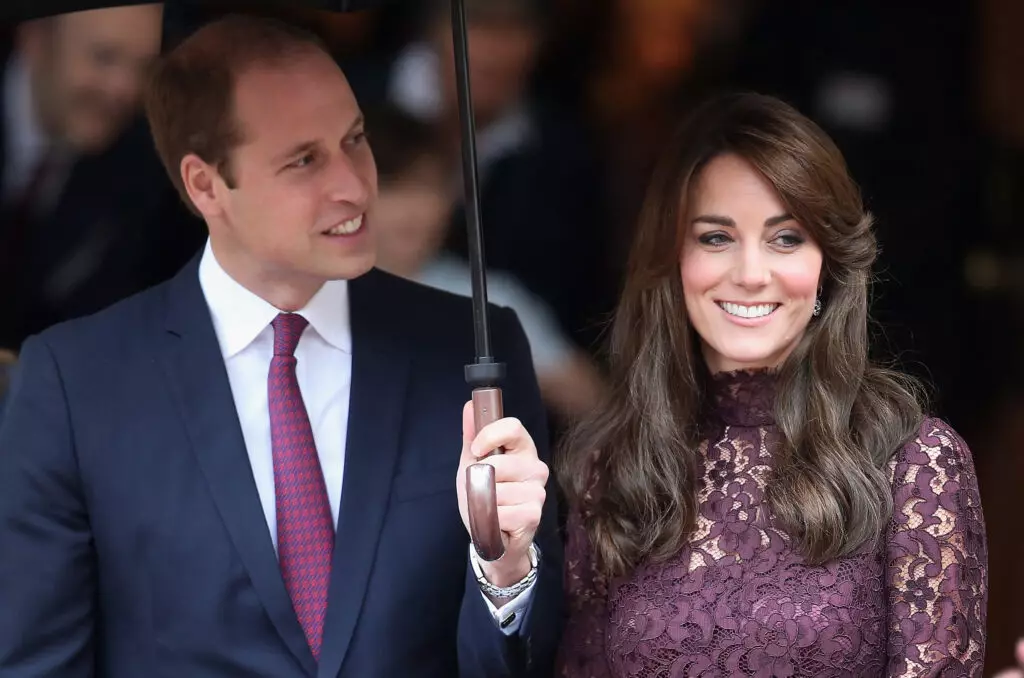 Putera William memegang payung untuk Kate Middleton