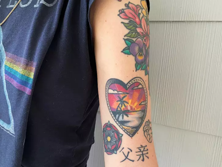 Le bras de la femme avec des tatouages colorés